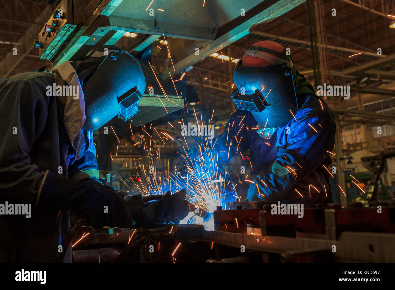 Workers are welding assembly steel part in factory Stock Photo - Alamy
