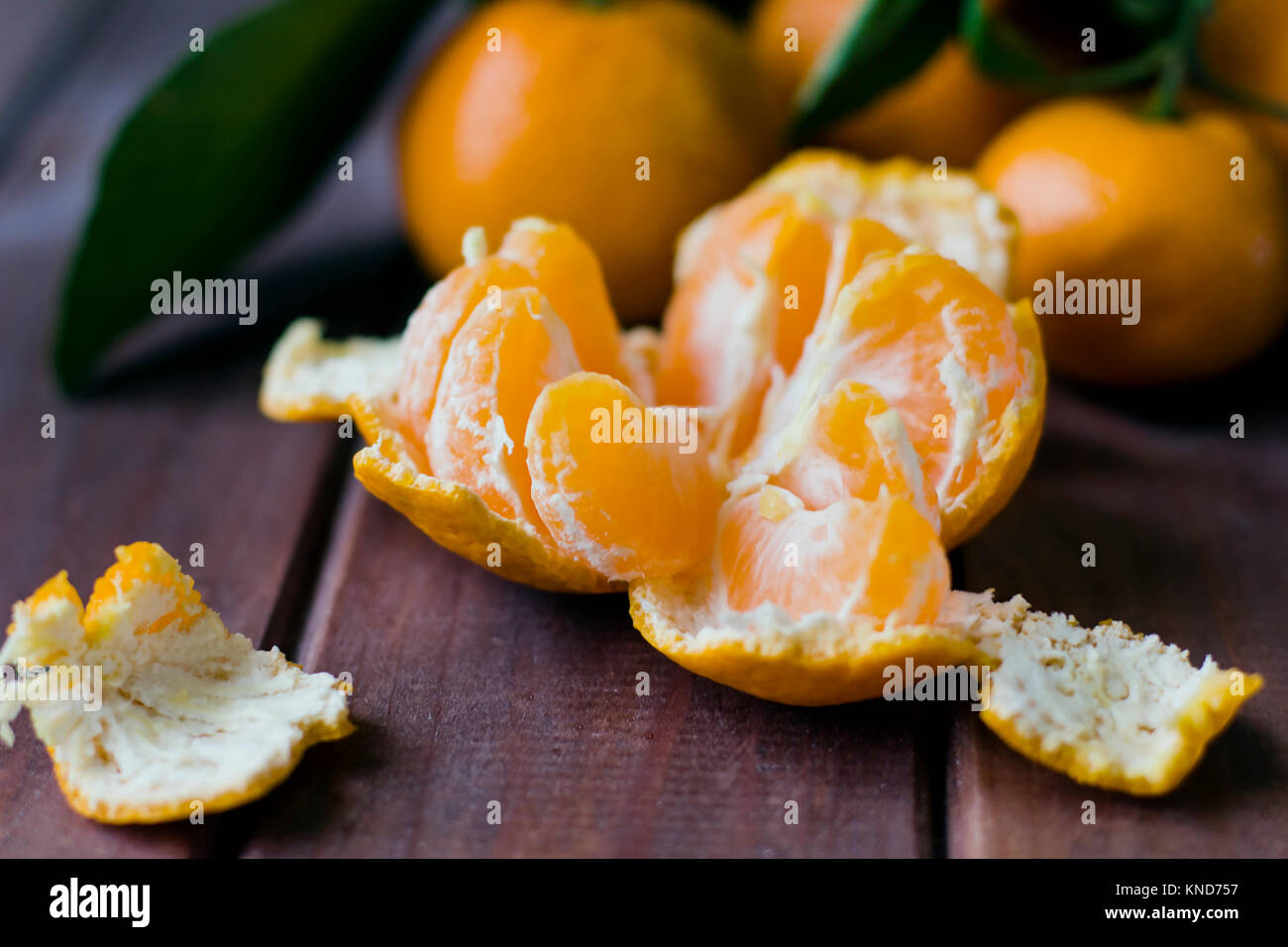 Fresh opened tangerine on wooden background Stock Photo - Alamy