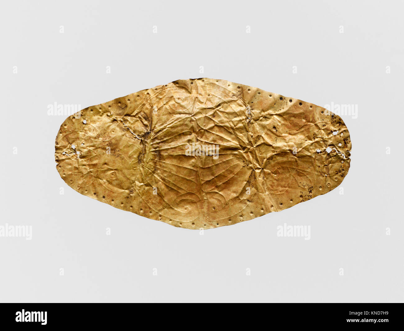 A gold leaf frontlet, designed as a band for the forehead, displayed in ...