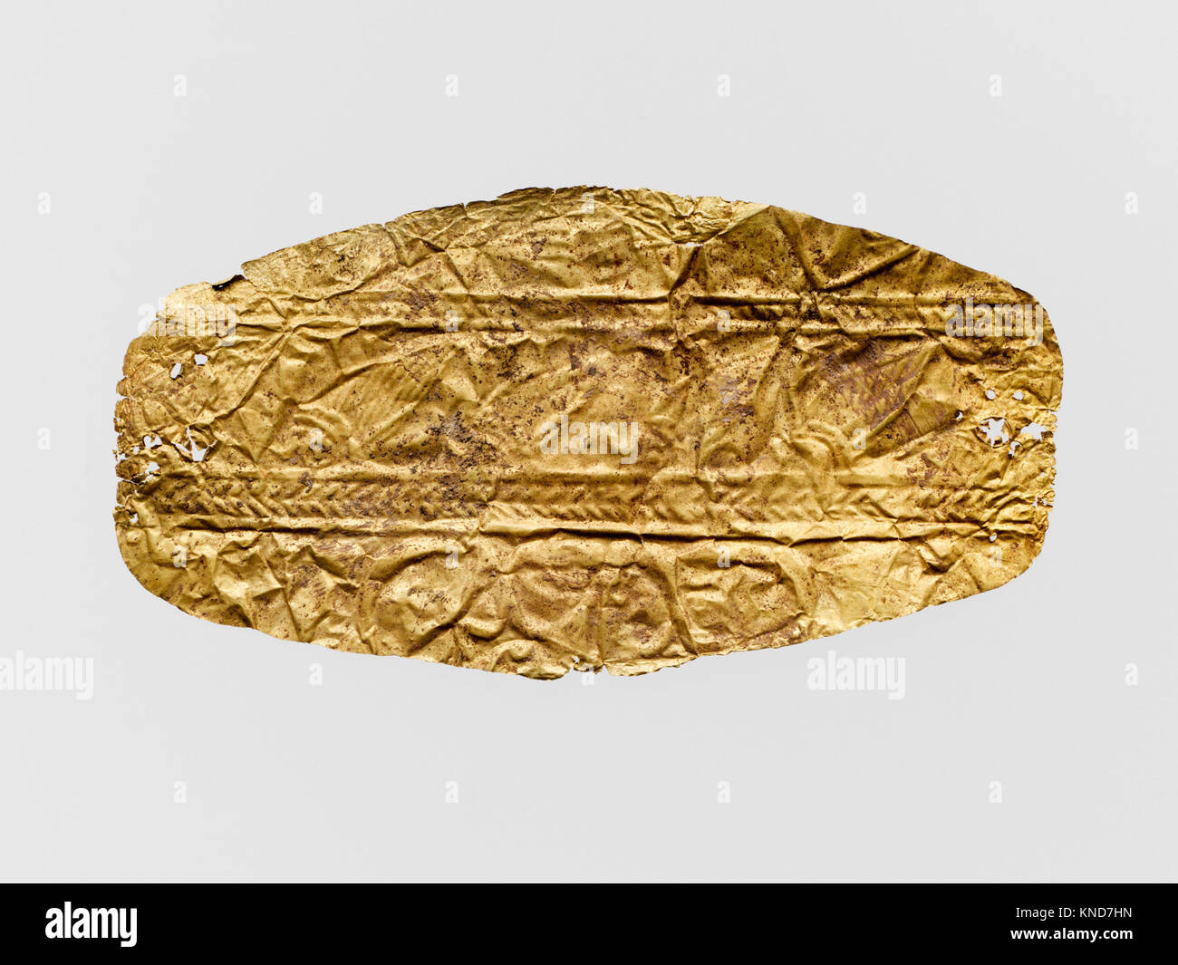 This gold leaf frontlet, used as a decorative forehead band ...
