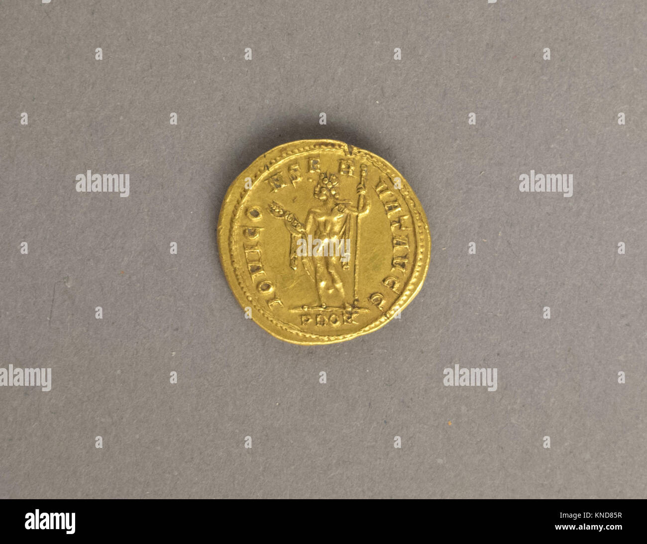 This gold aureus coin of Diocletian, a Roman emperor, reflects the ...