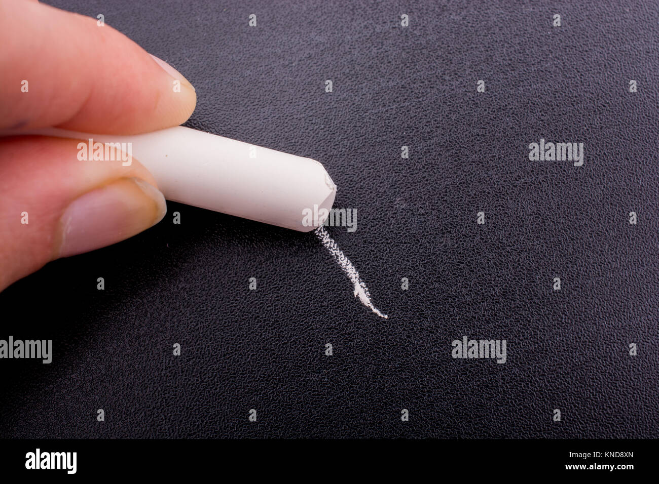 Hand holding white chalk and black board Stock Photo - Alamy
