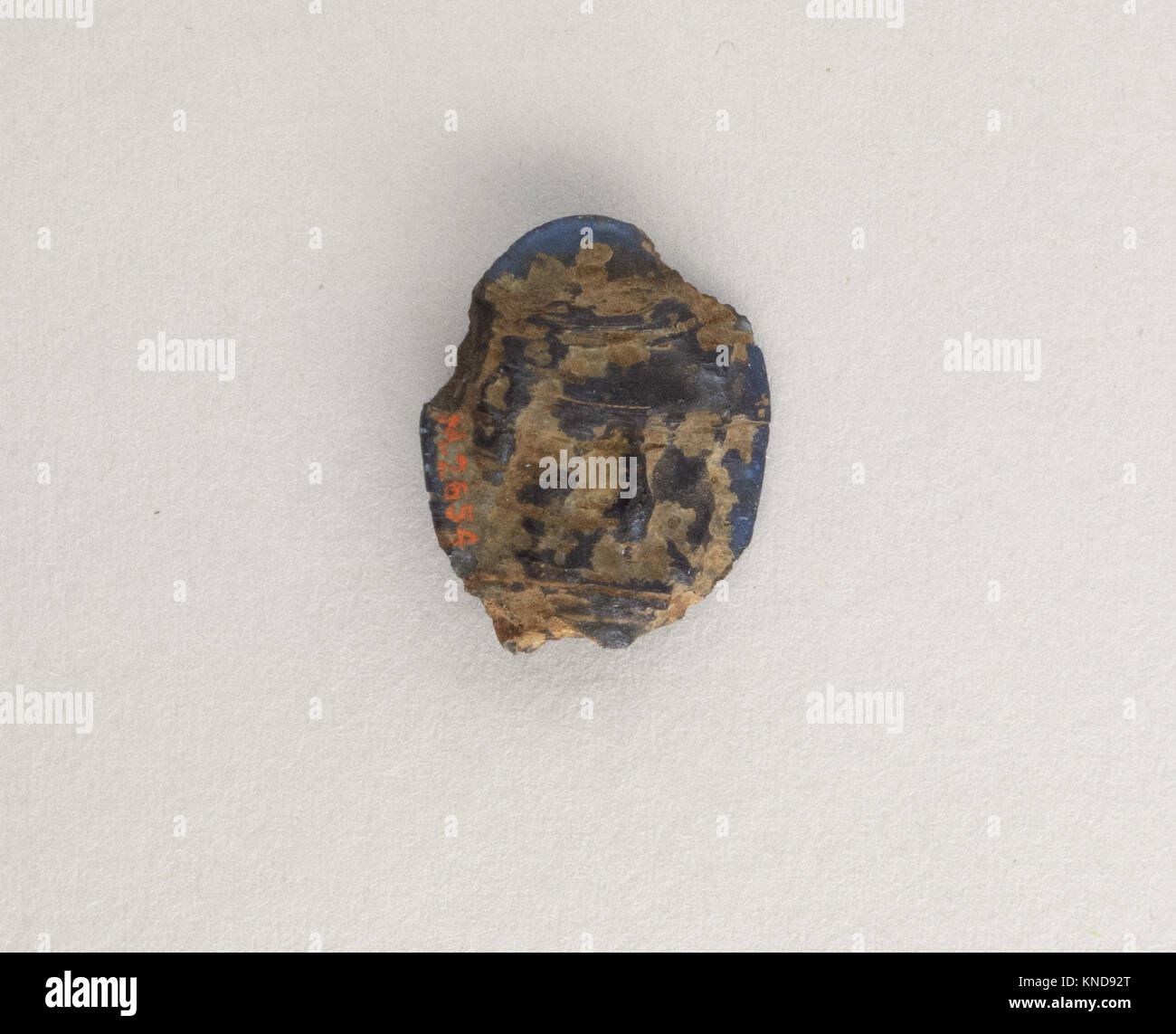 This glass pendant features a double-headed design, exemplifying ...