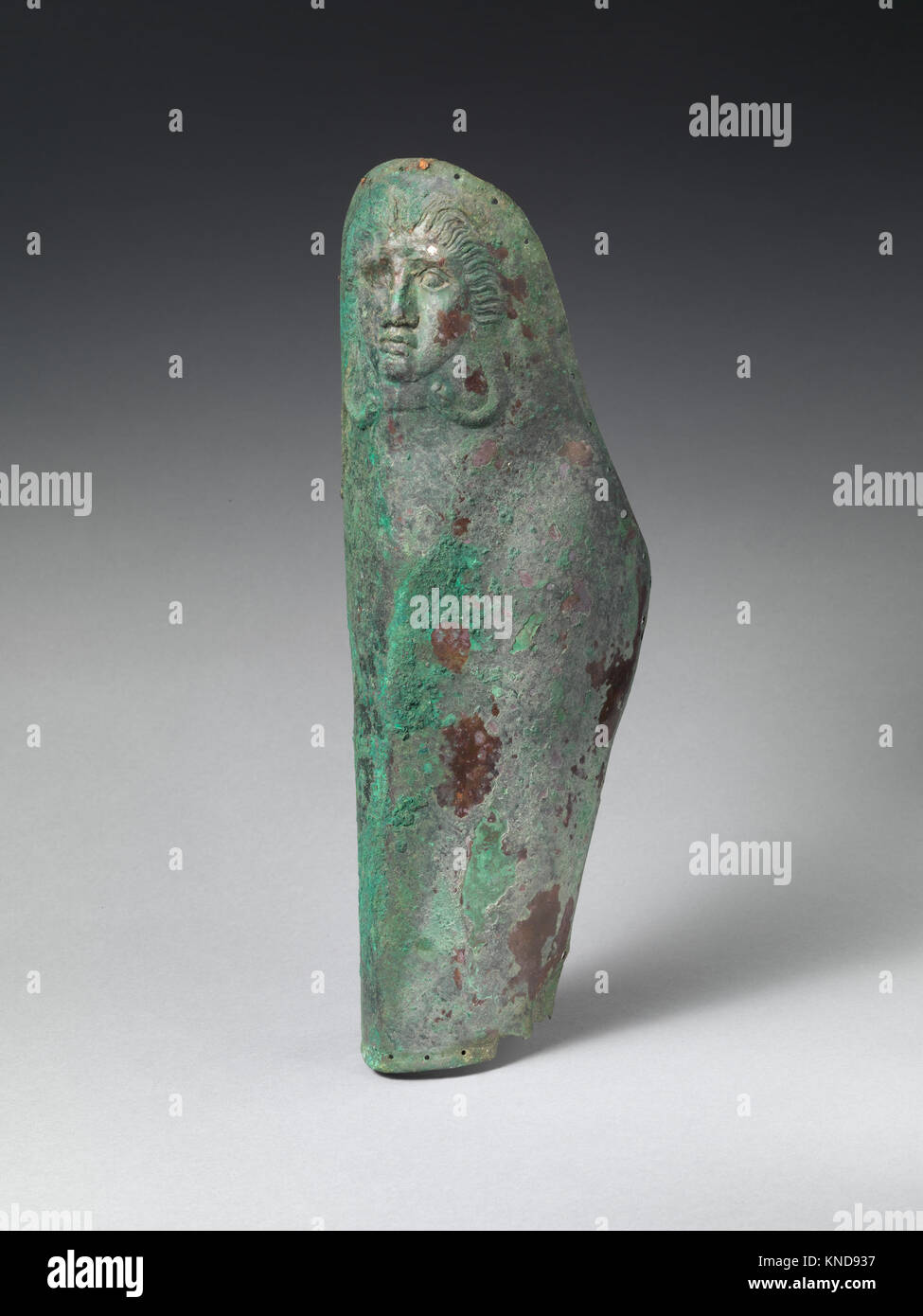 This bronze greave, a shin guard, represents armor used in ancient and ...