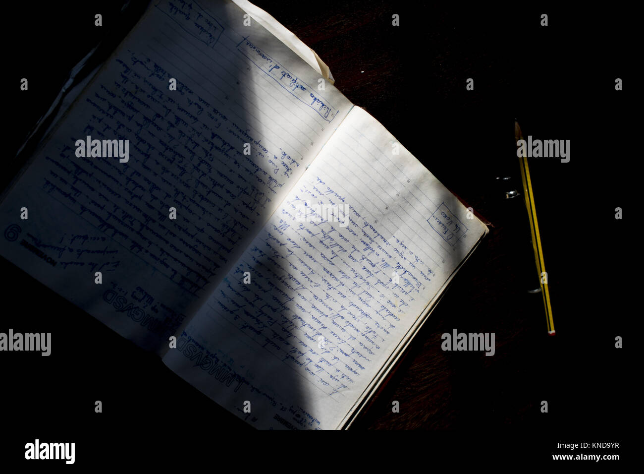 old manuscript diary illumined from lateral light Stock Photo - Alamy