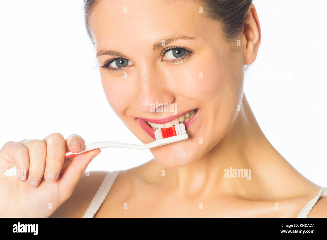 Portrait of a beautiful blond woman brushing her teeth Stock Photo - Alamy
