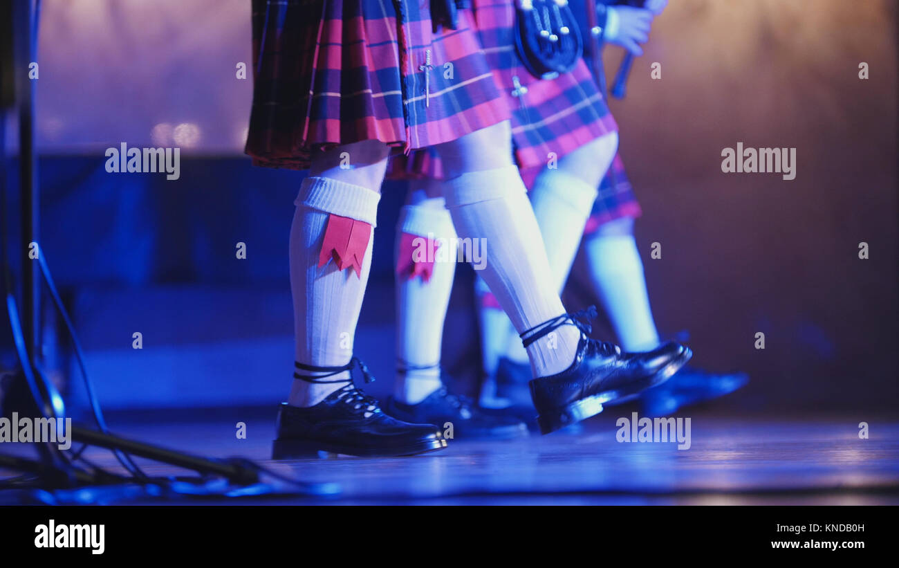 Traditional scottish band musicians singing with bagpipes on the stage ...