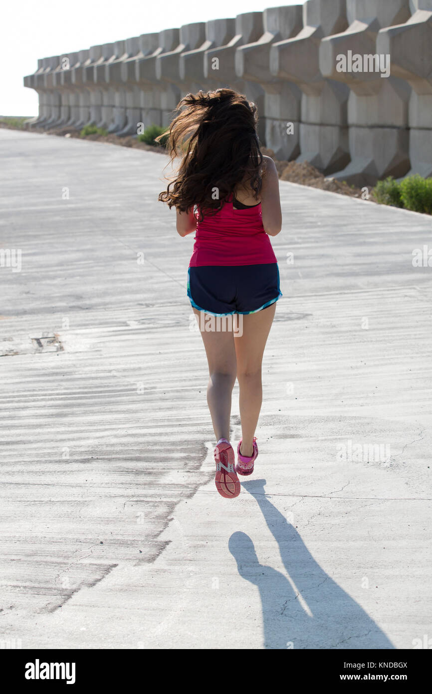 Rear view of a young woman running outdoors Stock Photo - Alamy