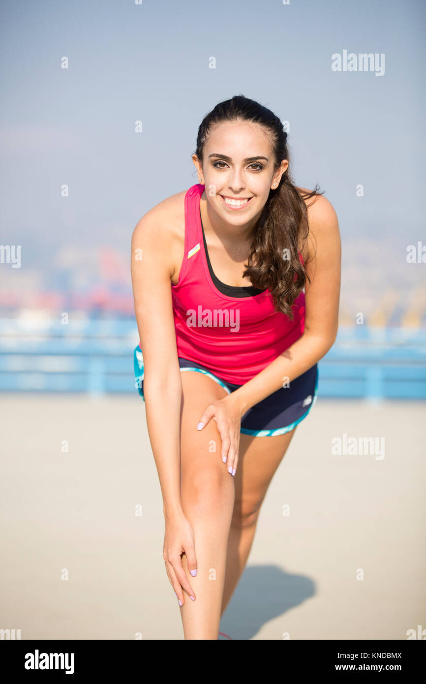 Healthy young woman bending down Stock Photo - Alamy