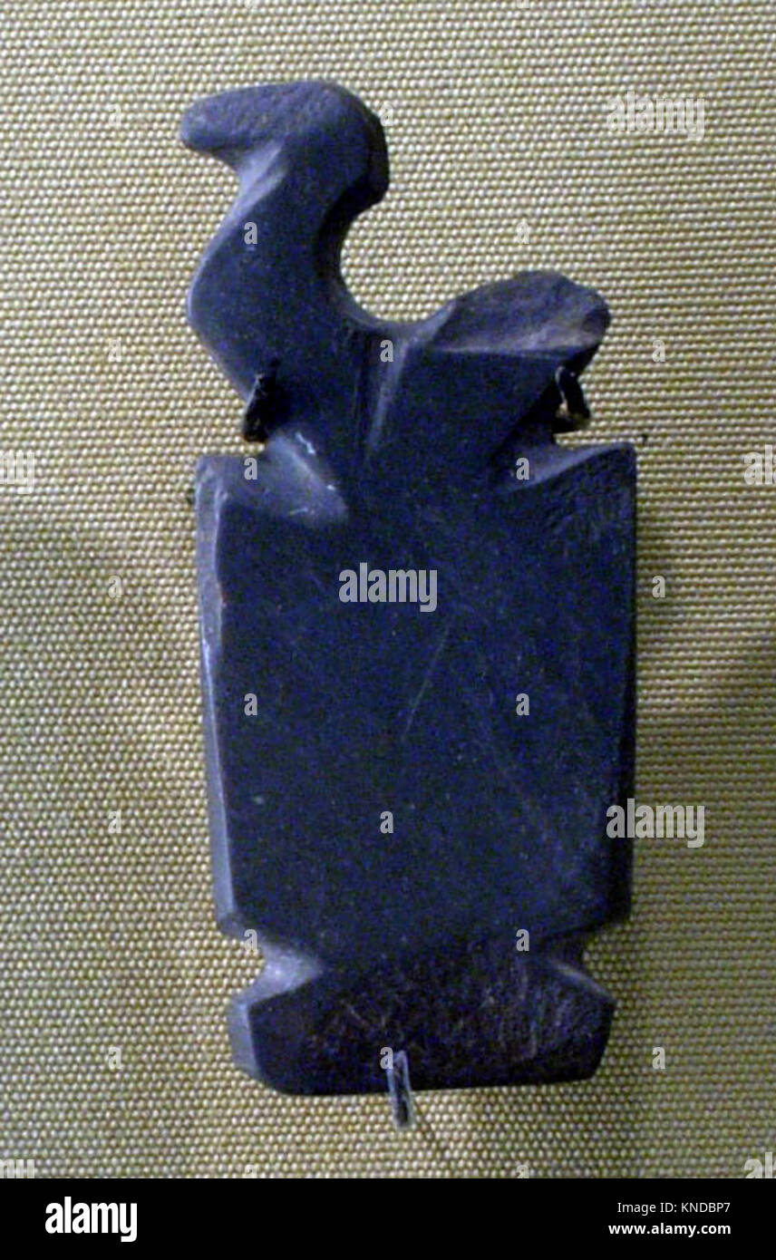 This amulet, shaped like two bird heads, is a rare example of ancient ...