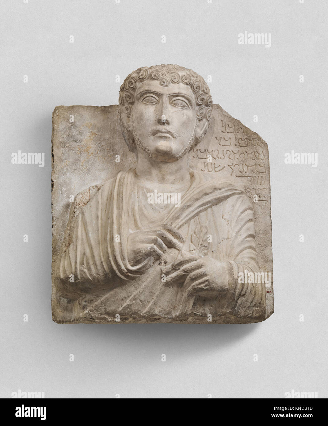 This funerary relief depicts a scene from ancient burial practices. It ...