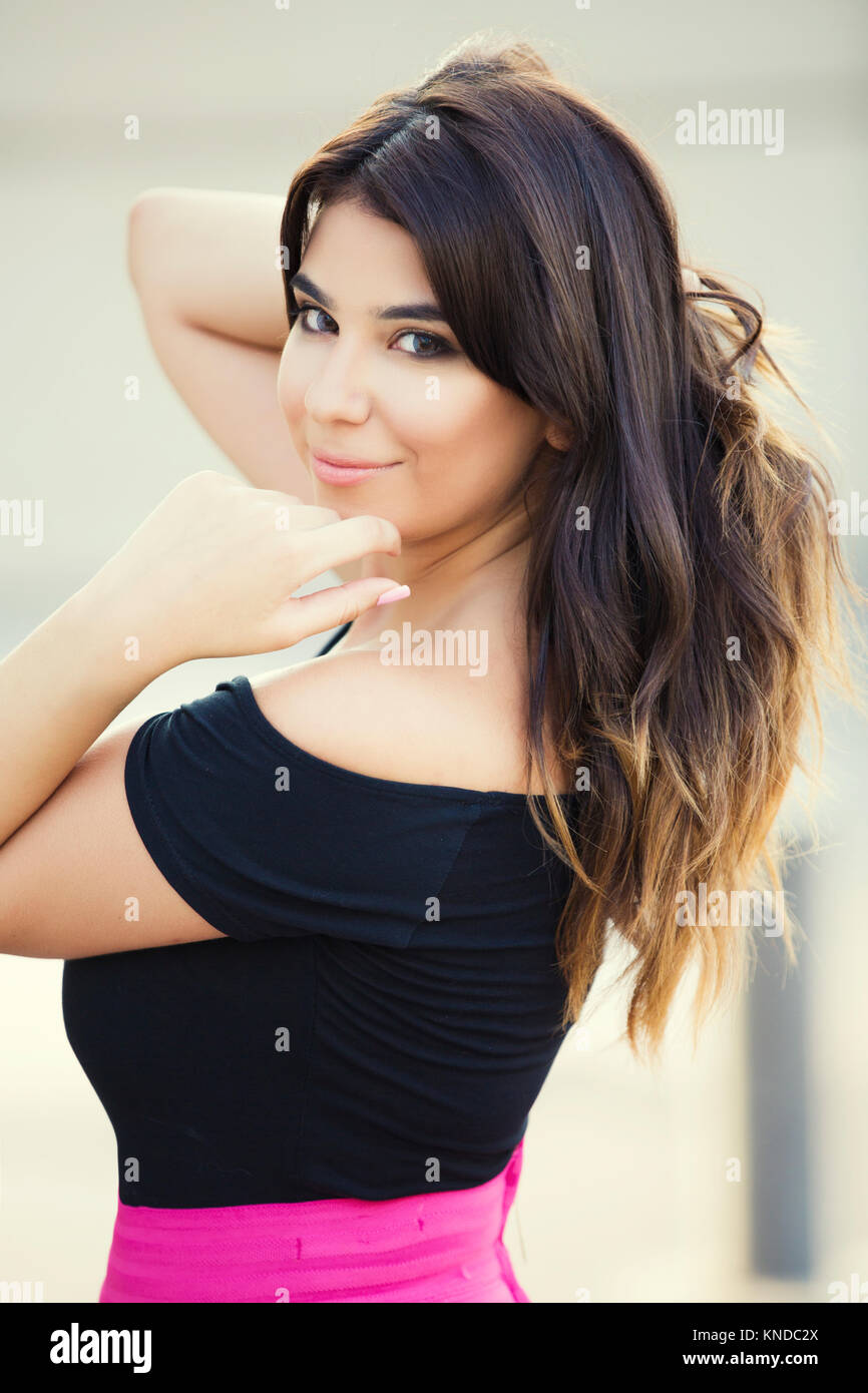 Beautiful young woman looking over shoulder hand on head smiling Stock ...