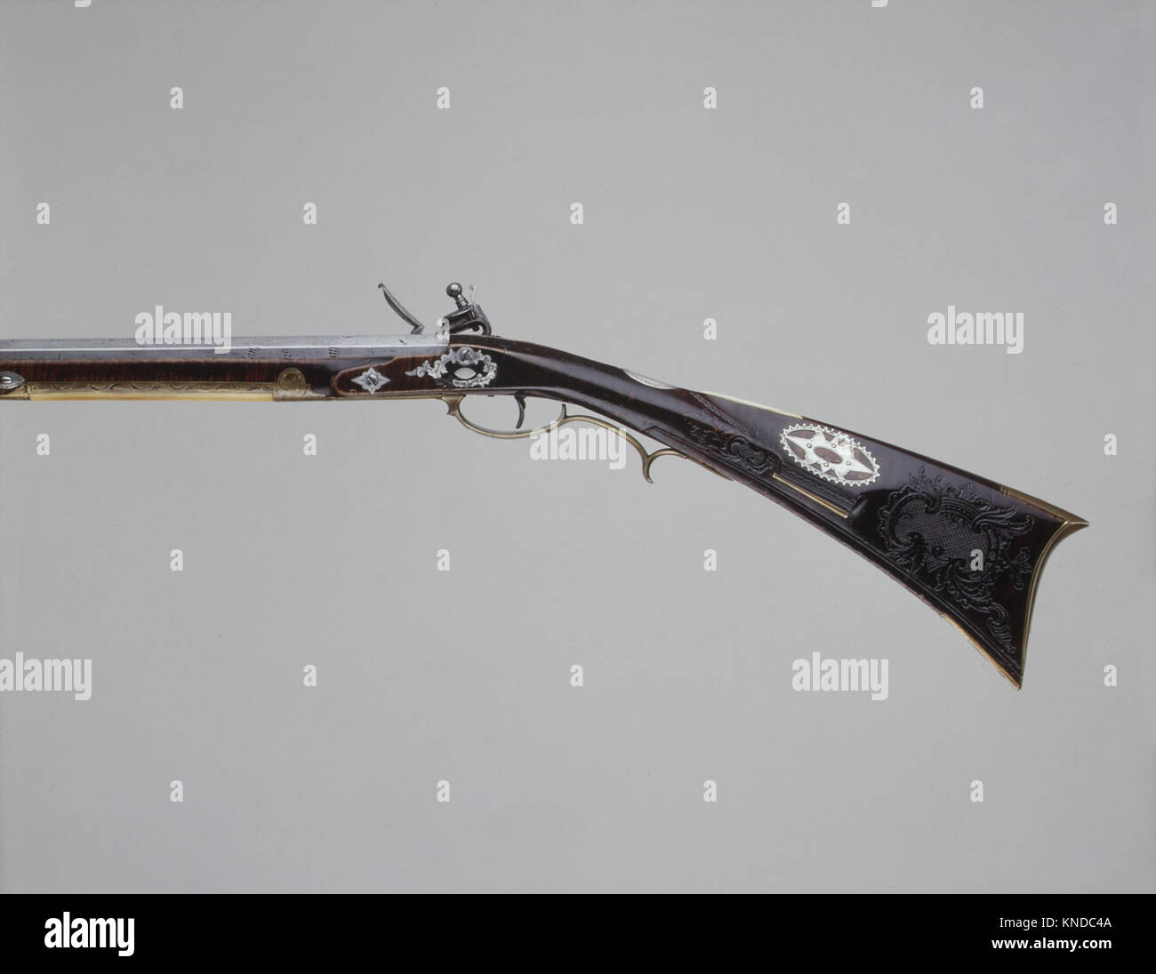 This flintlock rifle, dating back to the 17th or 18th century, is a ...