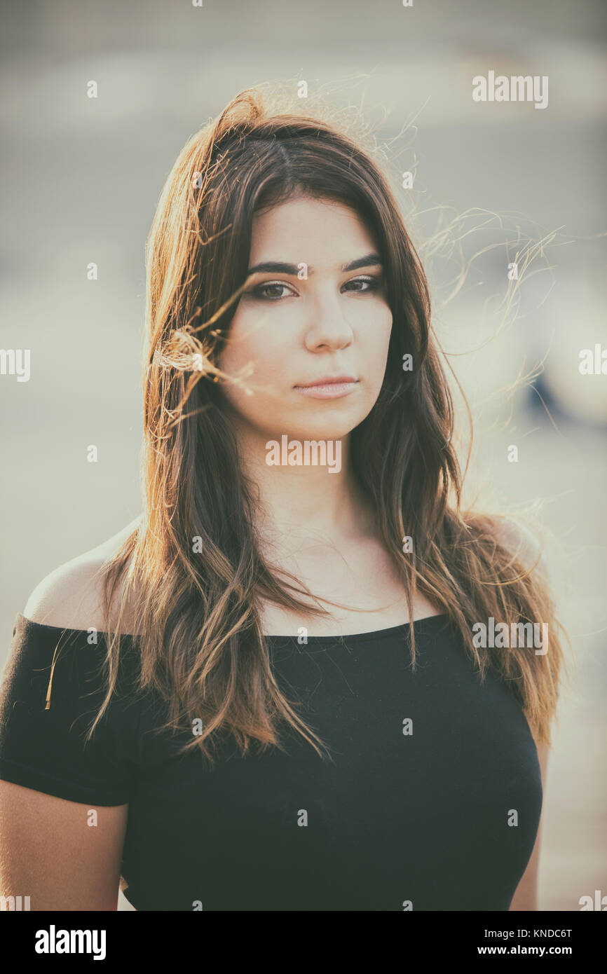 Serious young woman staring outdoors Stock Photo - Alamy
