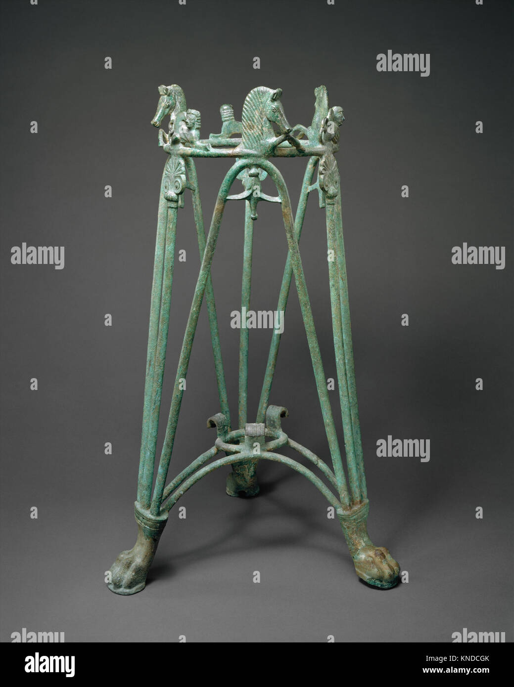 A bronze rod tripod stand, representative of ancient metalwork and ...