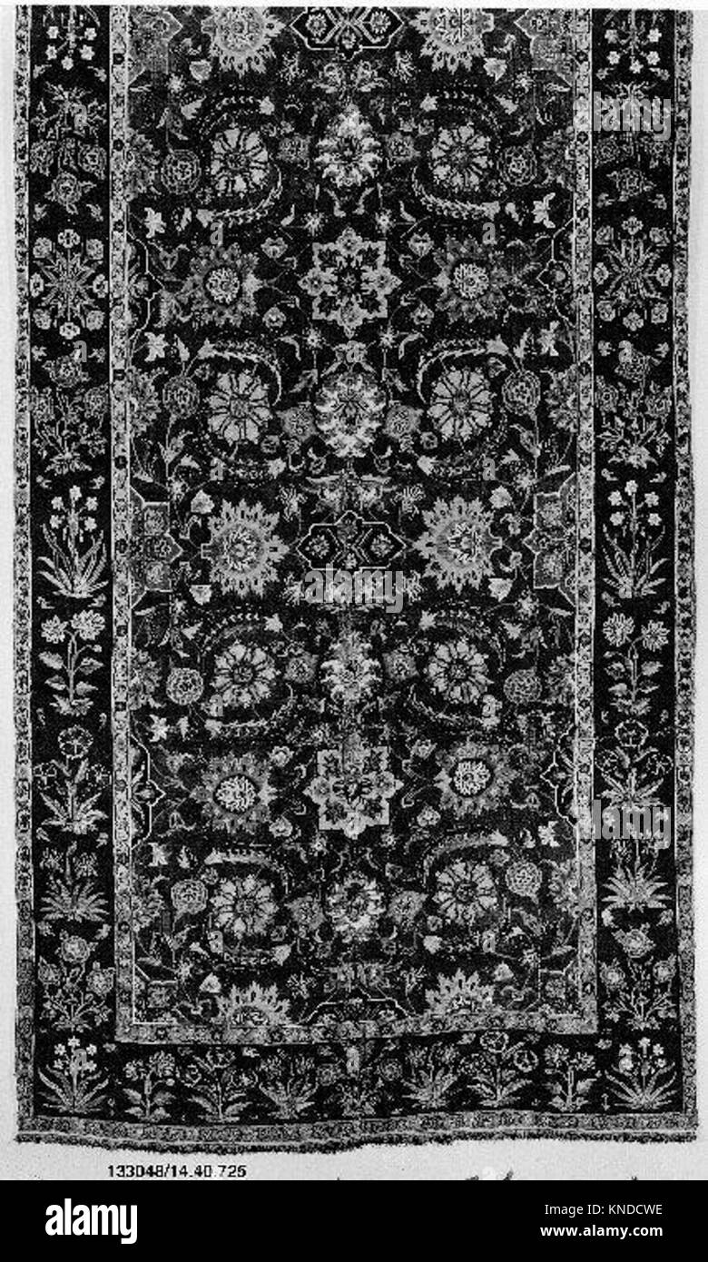 This carpet features a scrolling vine and blossom pattern, showcasing ...