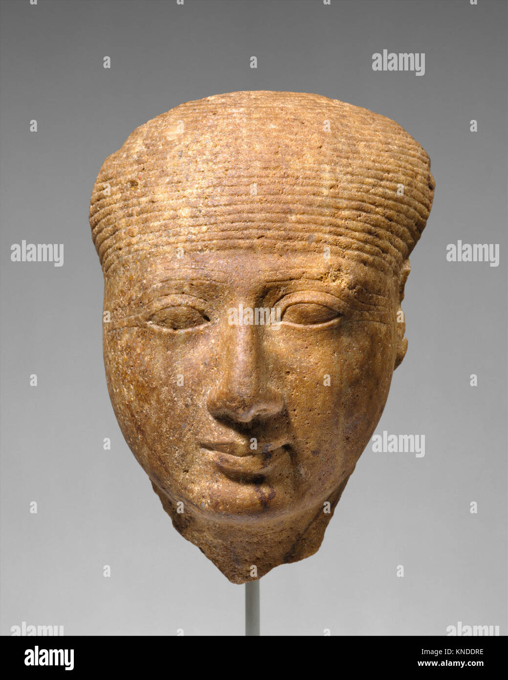 A sculpted head of a goddess, likely from ancient mythology. The ...
