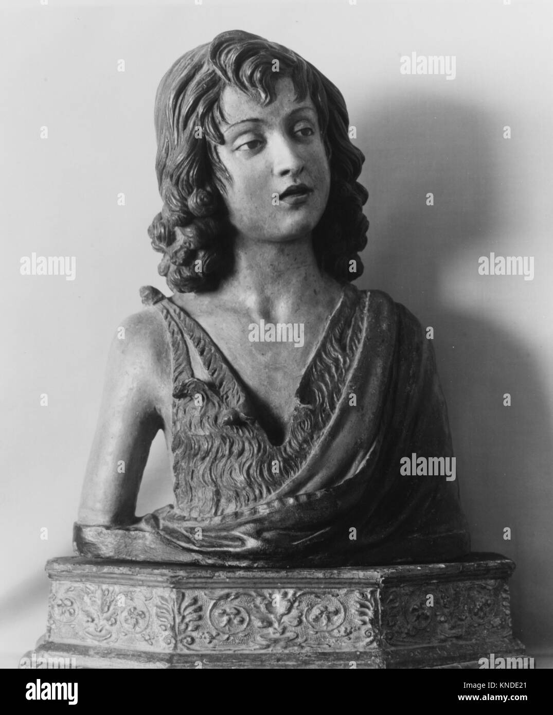 This painting depicts Saint John the Baptist with symbolic attributes ...