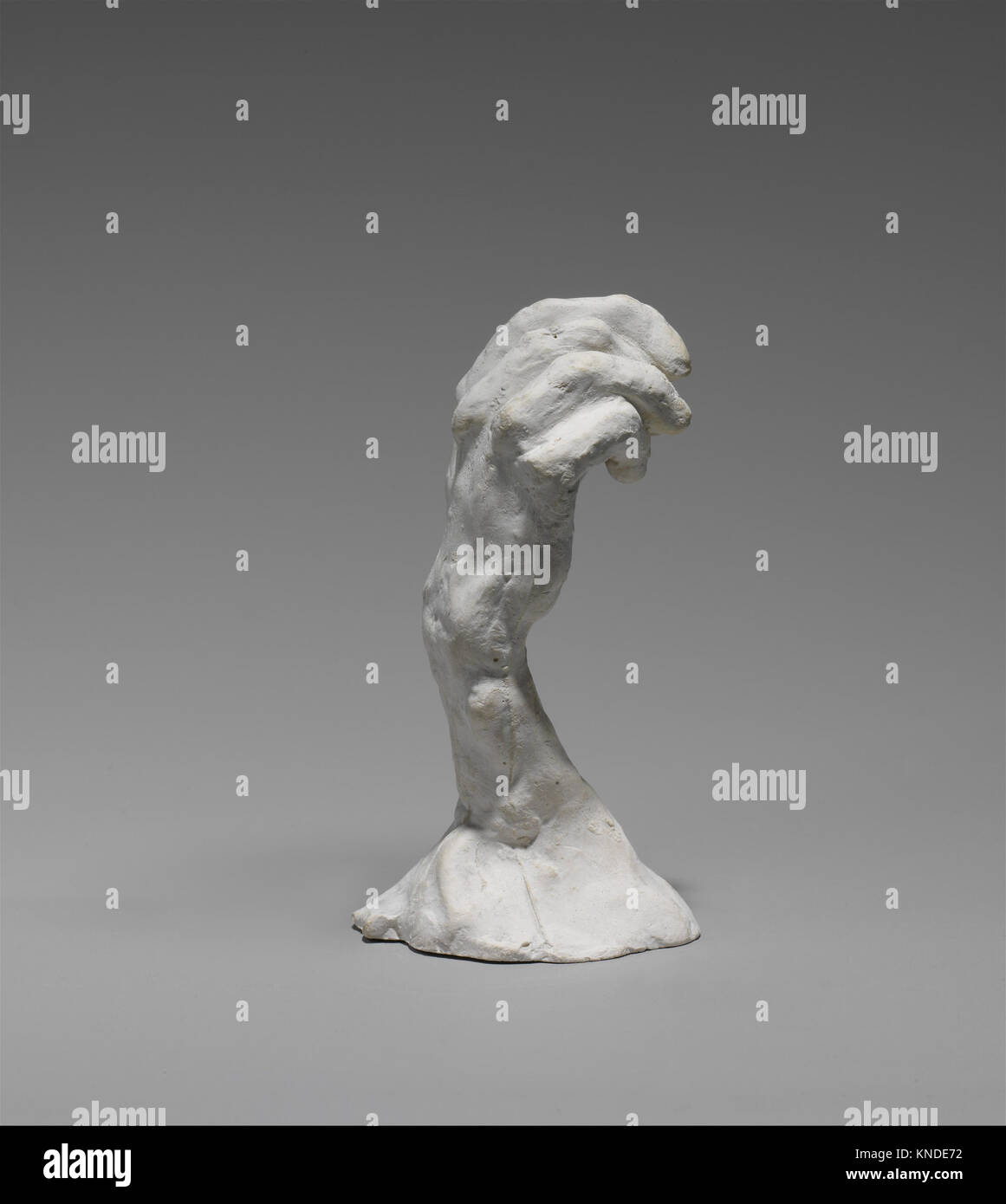 This sculpture of a hand with a base represents a stylized human figure ...