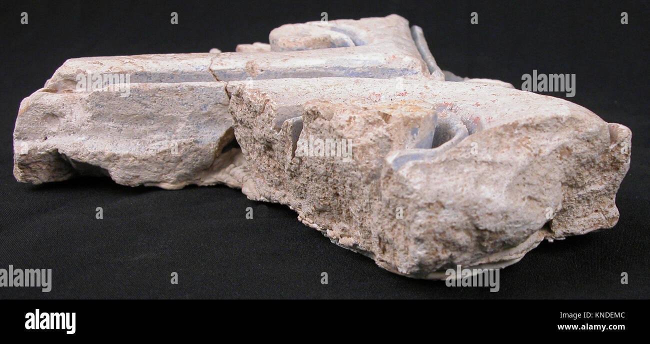 This fragment of molding features intricate design elements from a ...