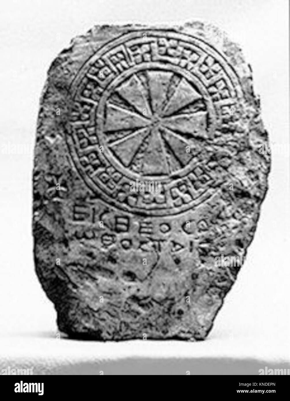 This funerary stele, featuring a wheel pattern, is an example of ...