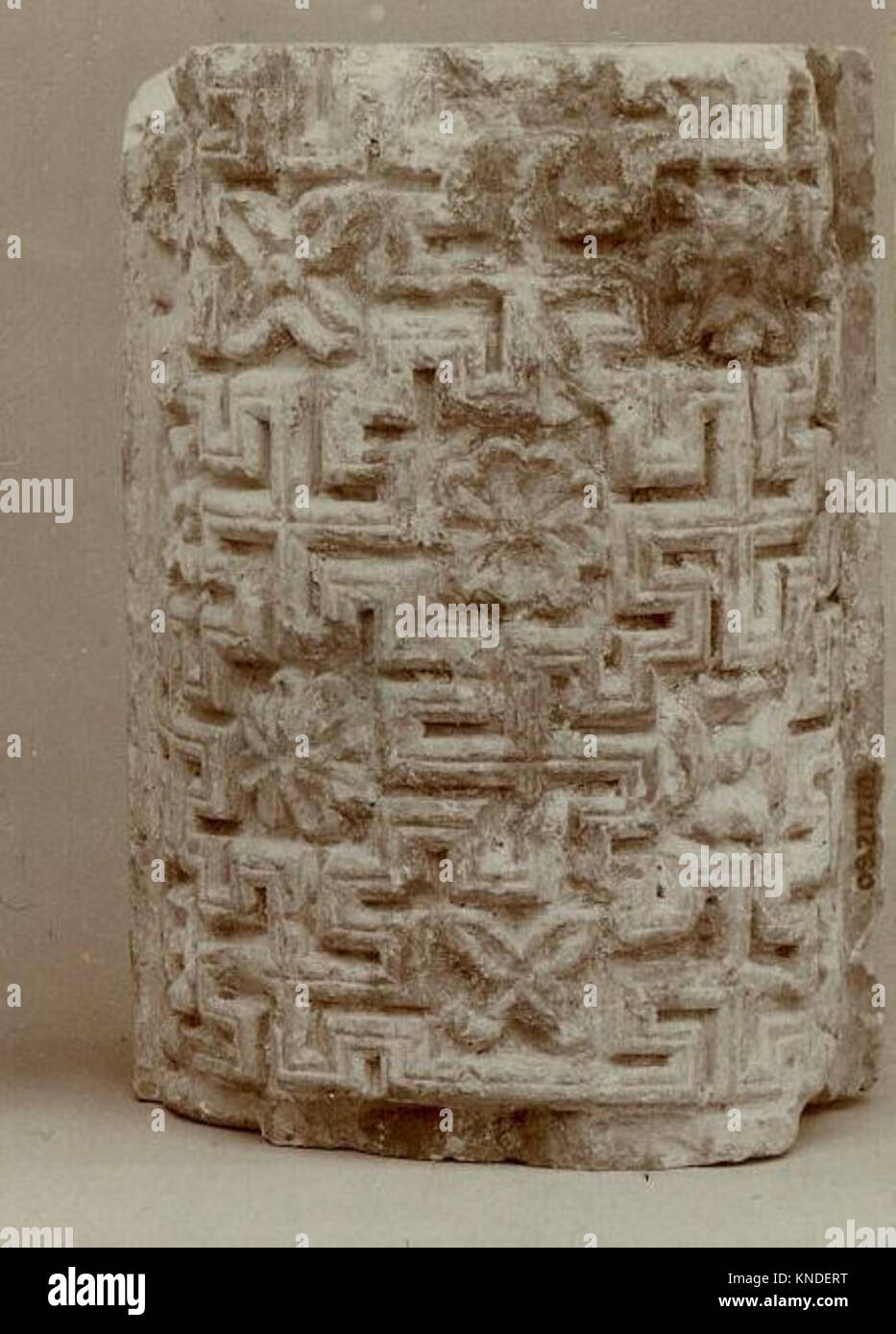 This piece of an engaged column features a meander pattern, a common ...
