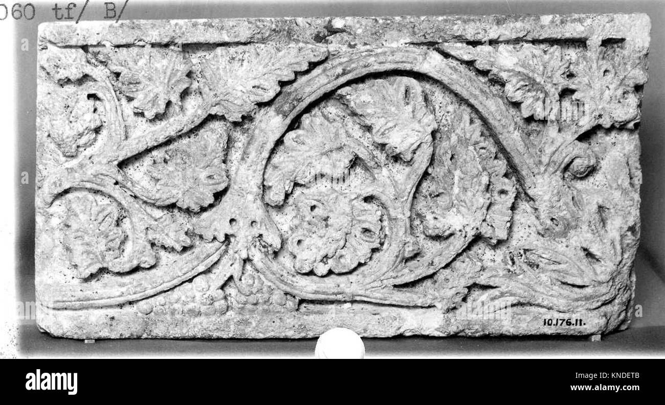 This fragment of a frieze features vine scrolls and grapes ...