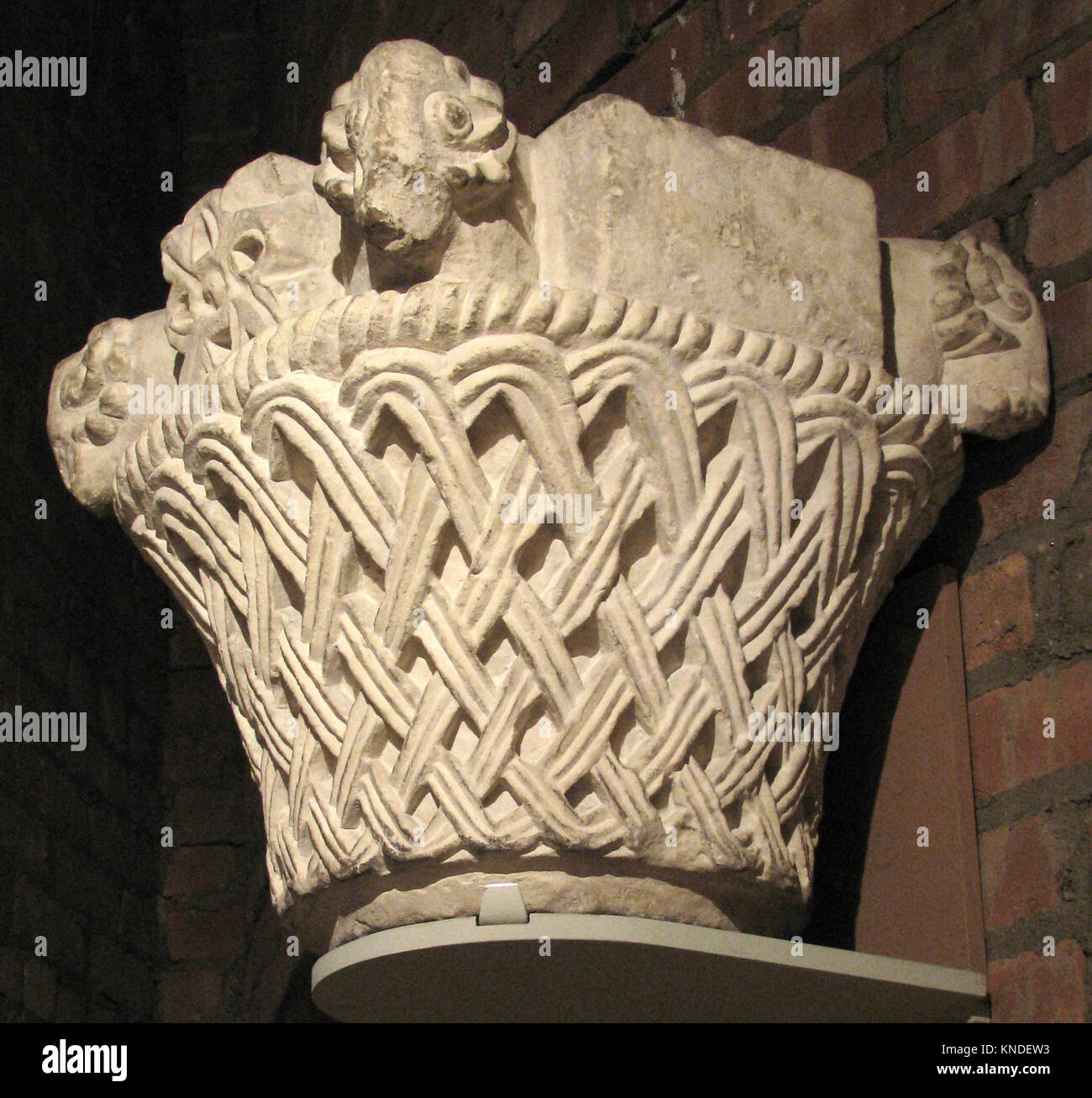 This architectural capital features a basket-weave pattern complemented ...