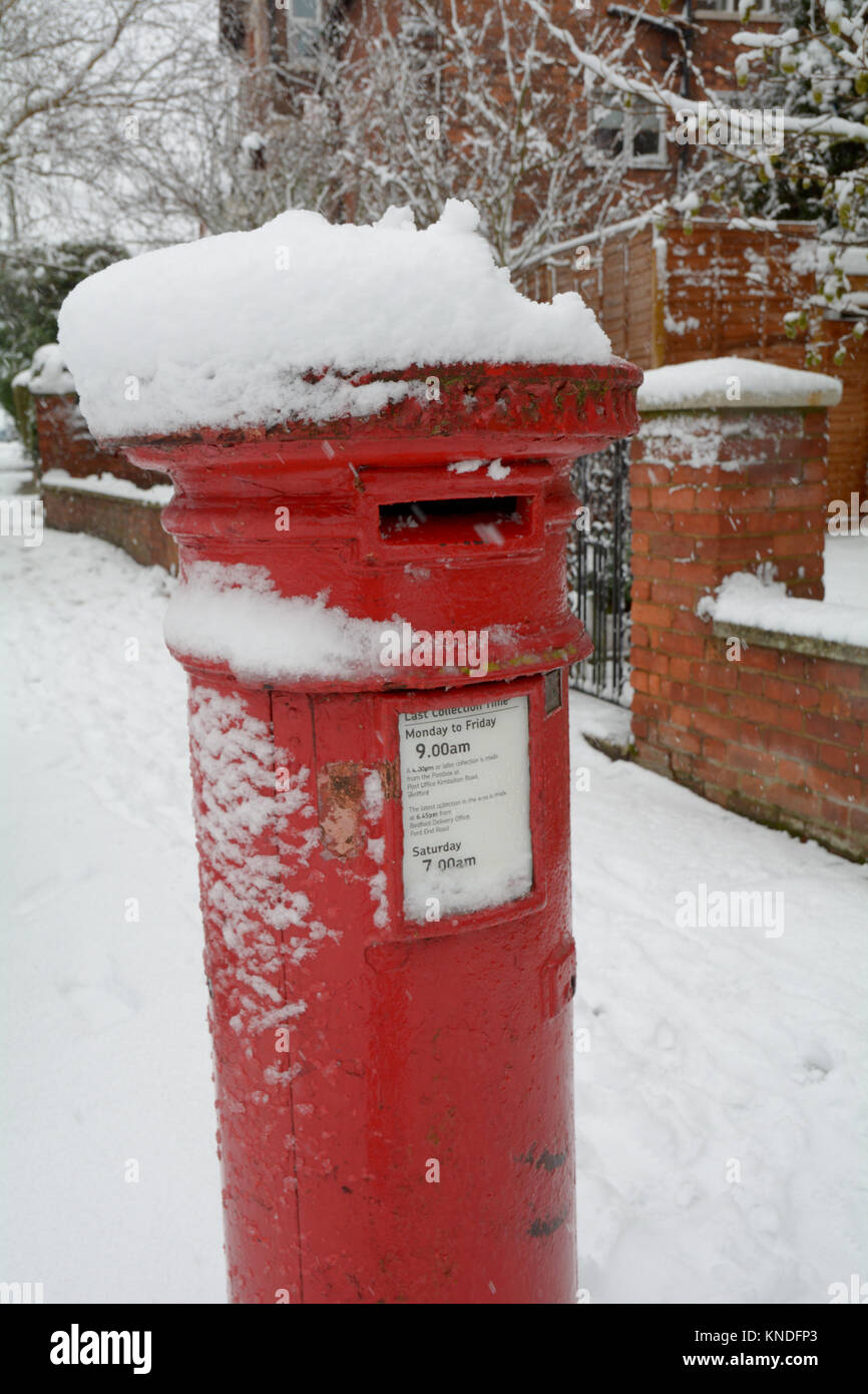 Red Royal Mail postbox covered in snow Stock Photo - Alamy