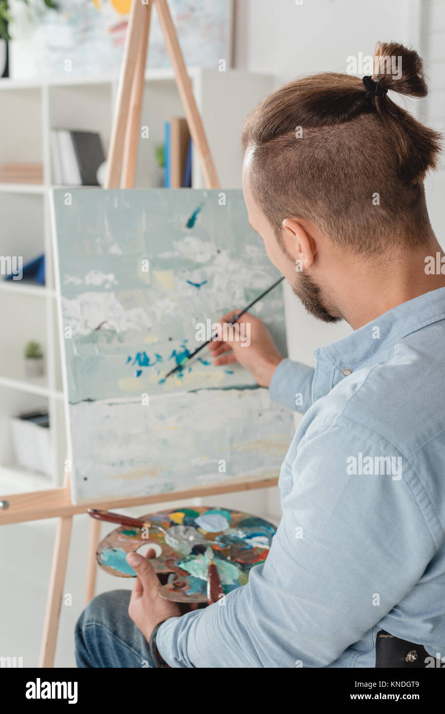 man painting on canvas Stock Photo - Alamy