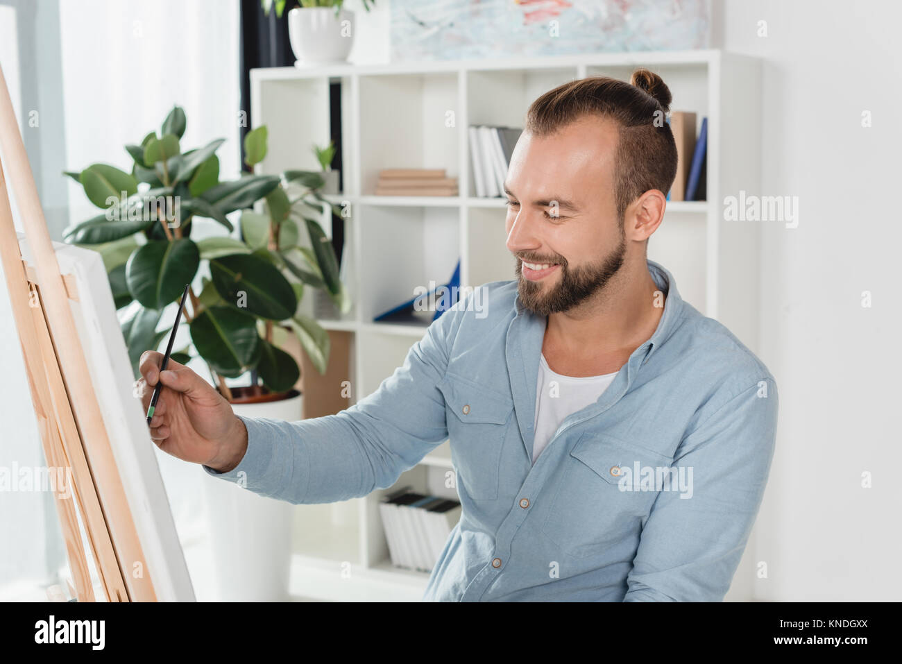 man painting on canvas Stock Photo - Alamy