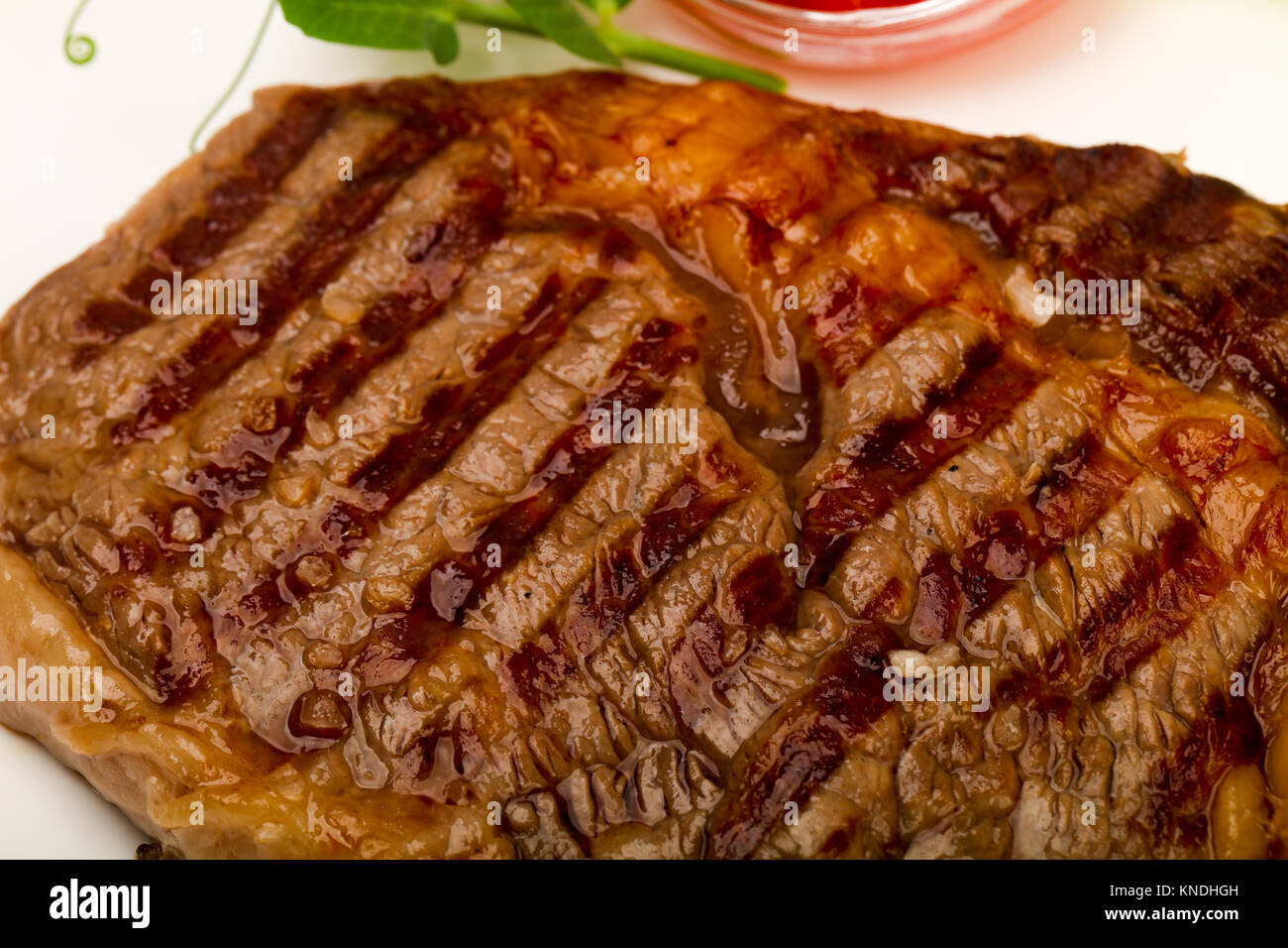 Grilled Rib eye steak with sauce Stock Photo - Alamy