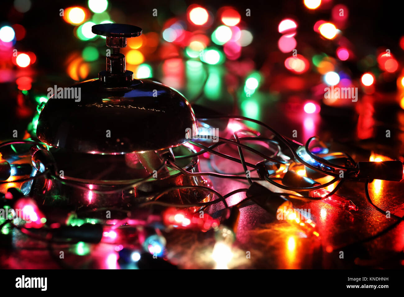 reception bell on table and color shining garland on background Stock ...