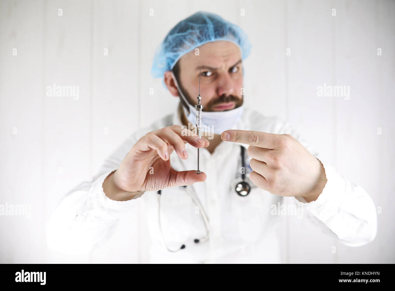 Crazy bearded doctor in a white coat and old syringe Stock Photo - Alamy