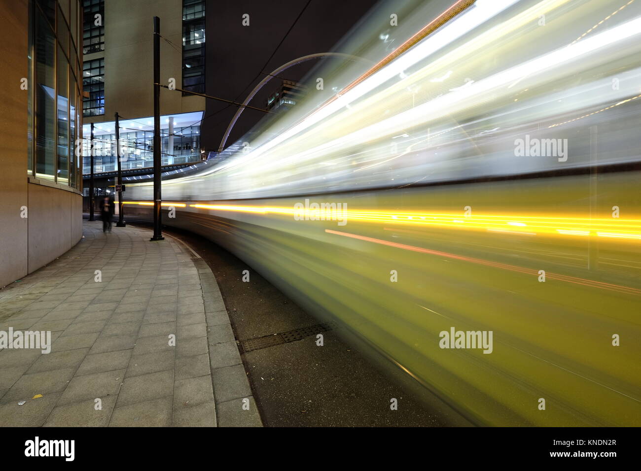 Manchester city centre at night with trams in motion Stock Photo - Alamy