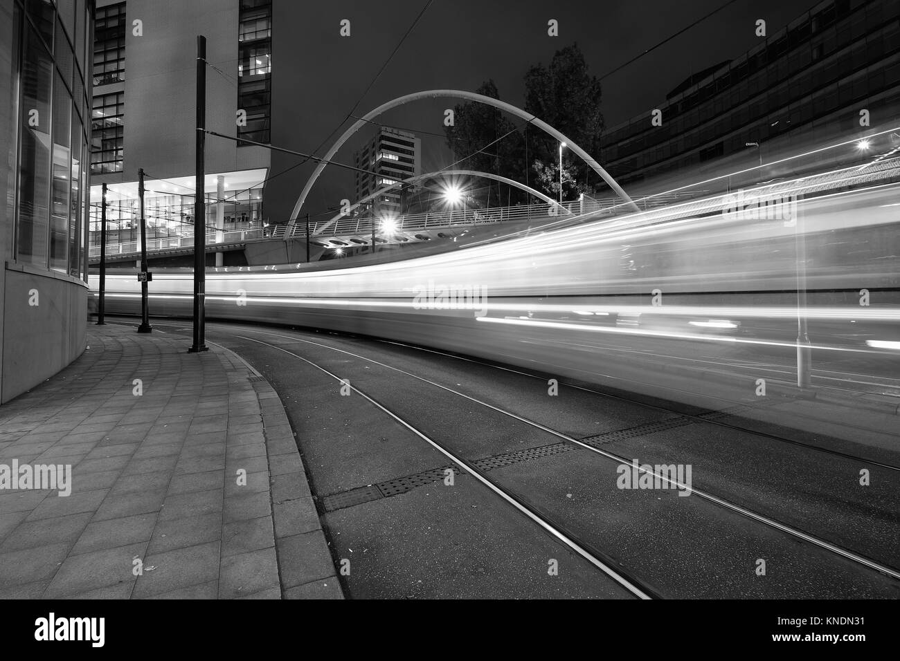 Manchester city centre at night with trams in motion Stock Photo - Alamy