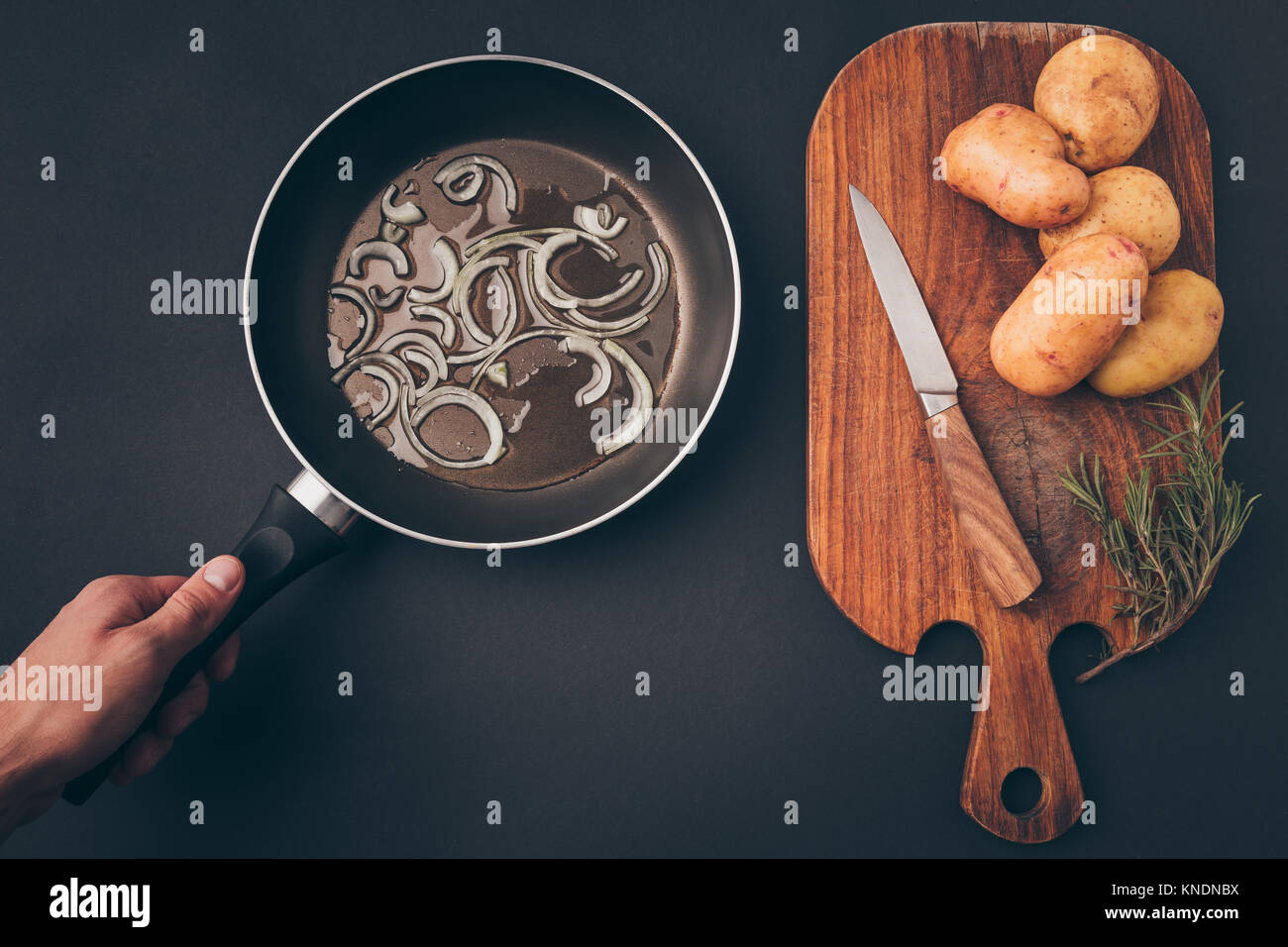 man putting frying pan Stock Photo - Alamy