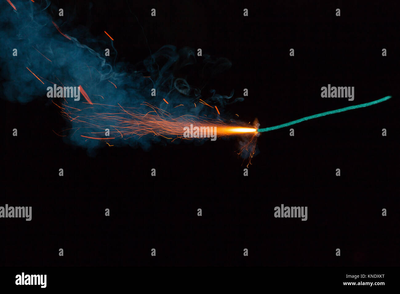 Burning fuse with sparks and blue smoke on black background Stock Photo ...