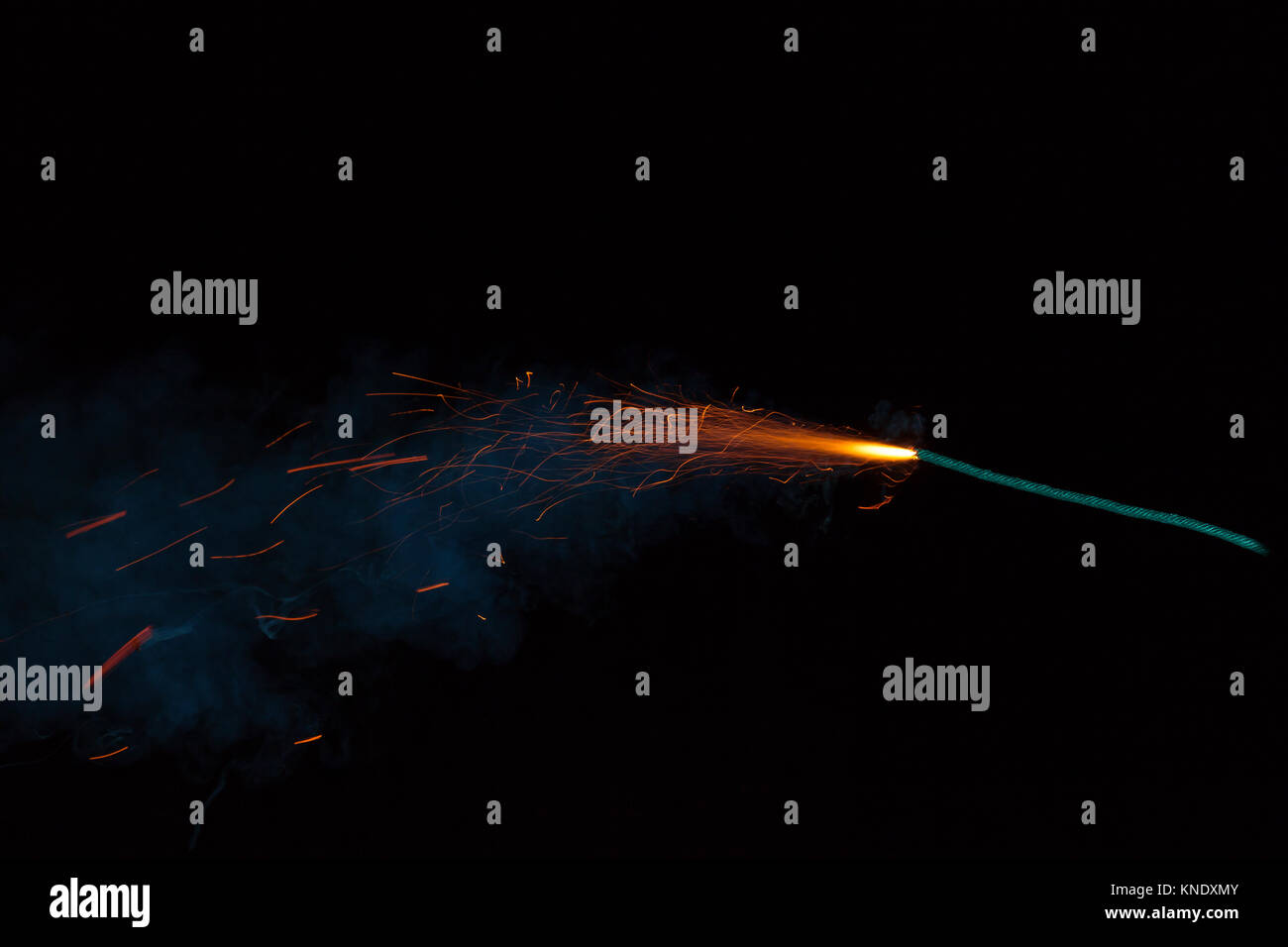 Burning fuse with sparks and blue smoke on black background Stock Photo ...