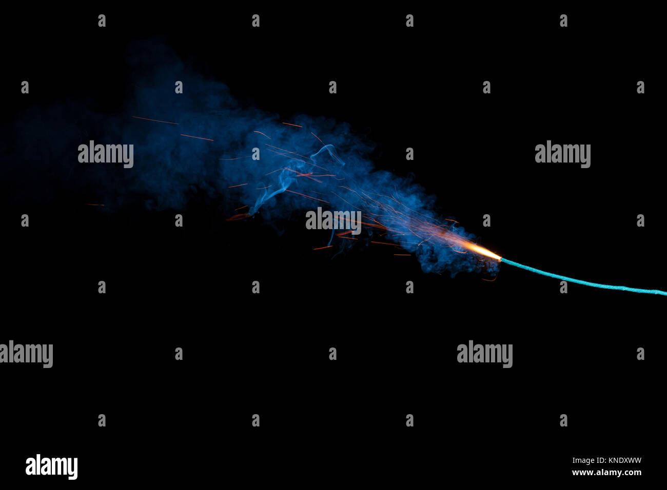 Burning fuse with sparks and blue smoke isolated on black background ...
