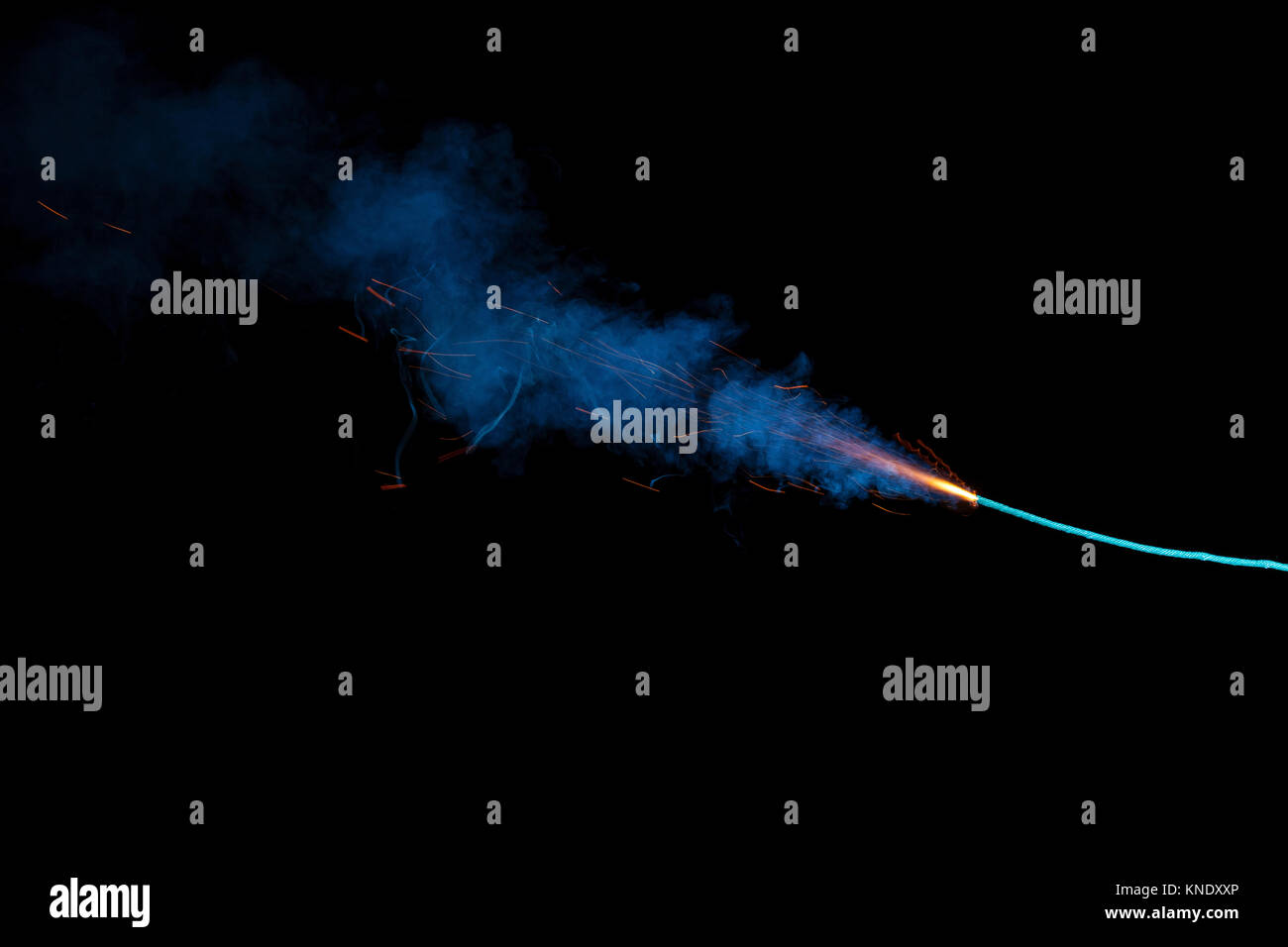Burning fuse with sparks and blue smoke isolated on black background ...