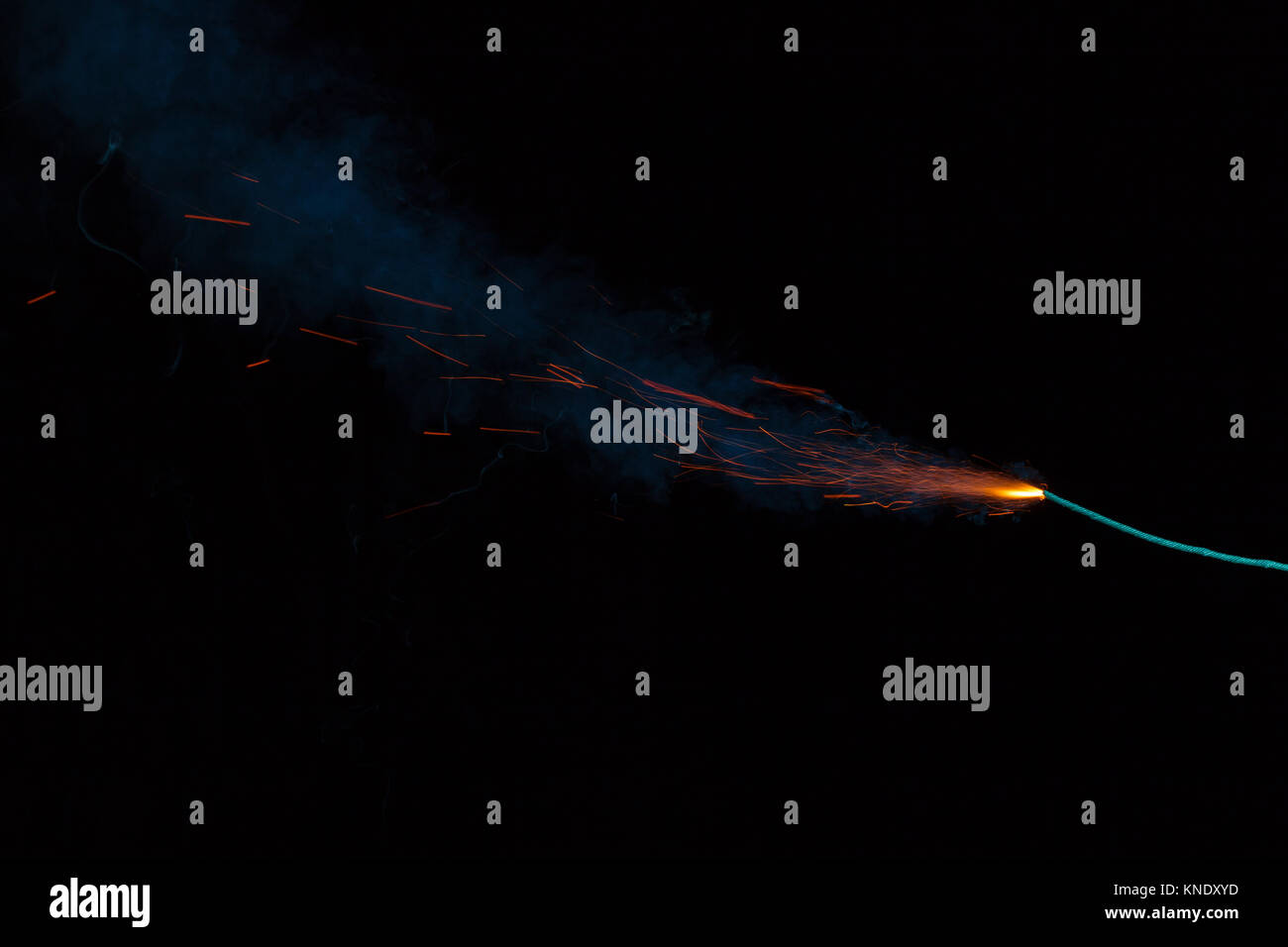 Burning fuse with sparks and blue smoke on black background Stock Photo ...