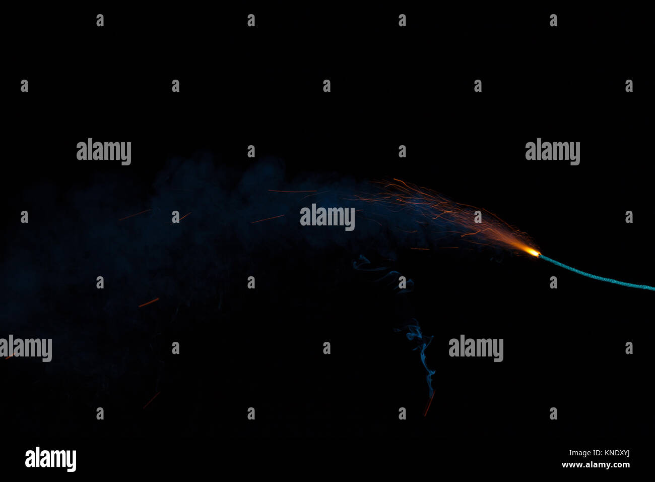 Burning fuse with sparks and blue smoke on black background Stock Photo ...