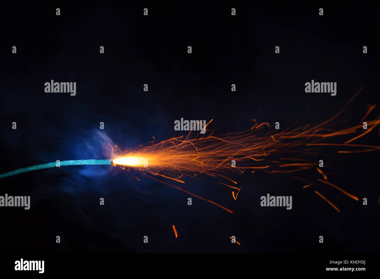 Burning fuse with sparks and blue smoke on black background Stock Photo ...