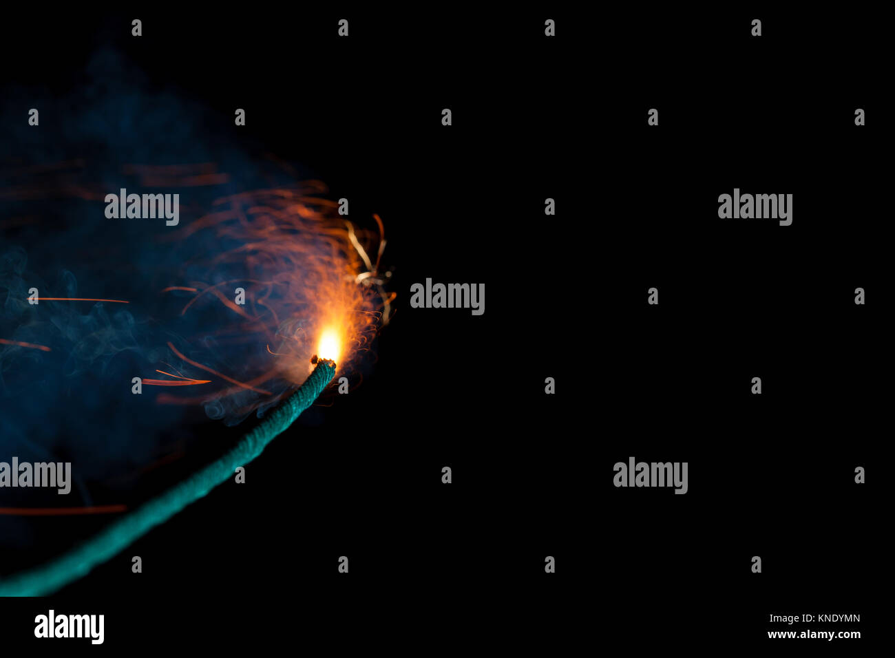 Burning fuse with sparks and blue smoke on black background Stock Photo ...