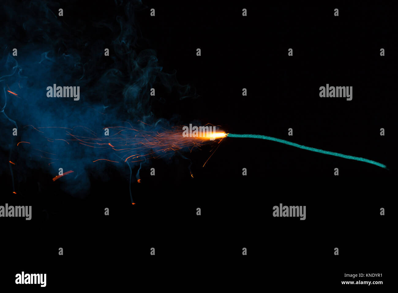 Burning fuse with sparks and blue smoke on black background Stock Photo ...