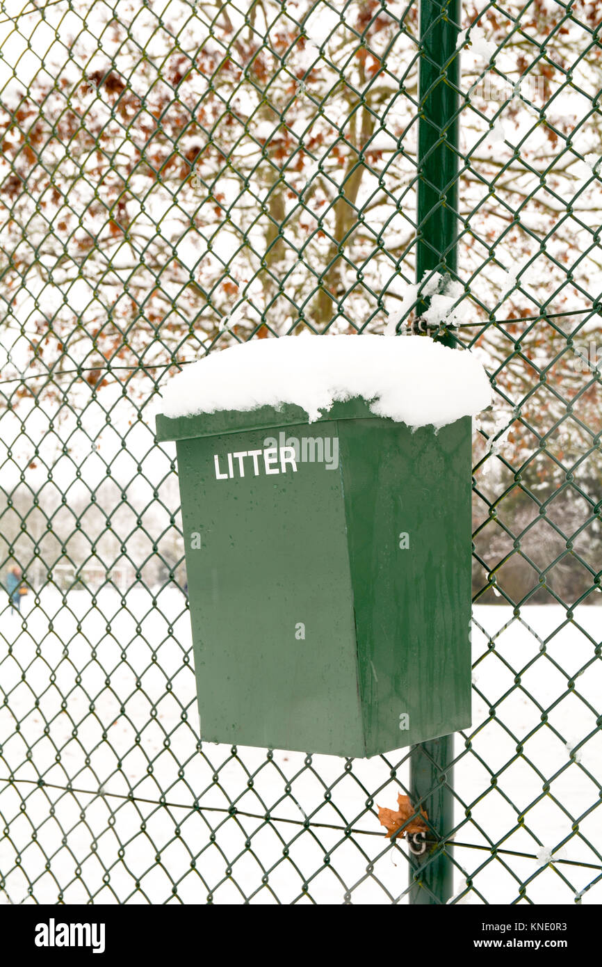 Green litter bin in park covered in snow Stock Photo - Alamy