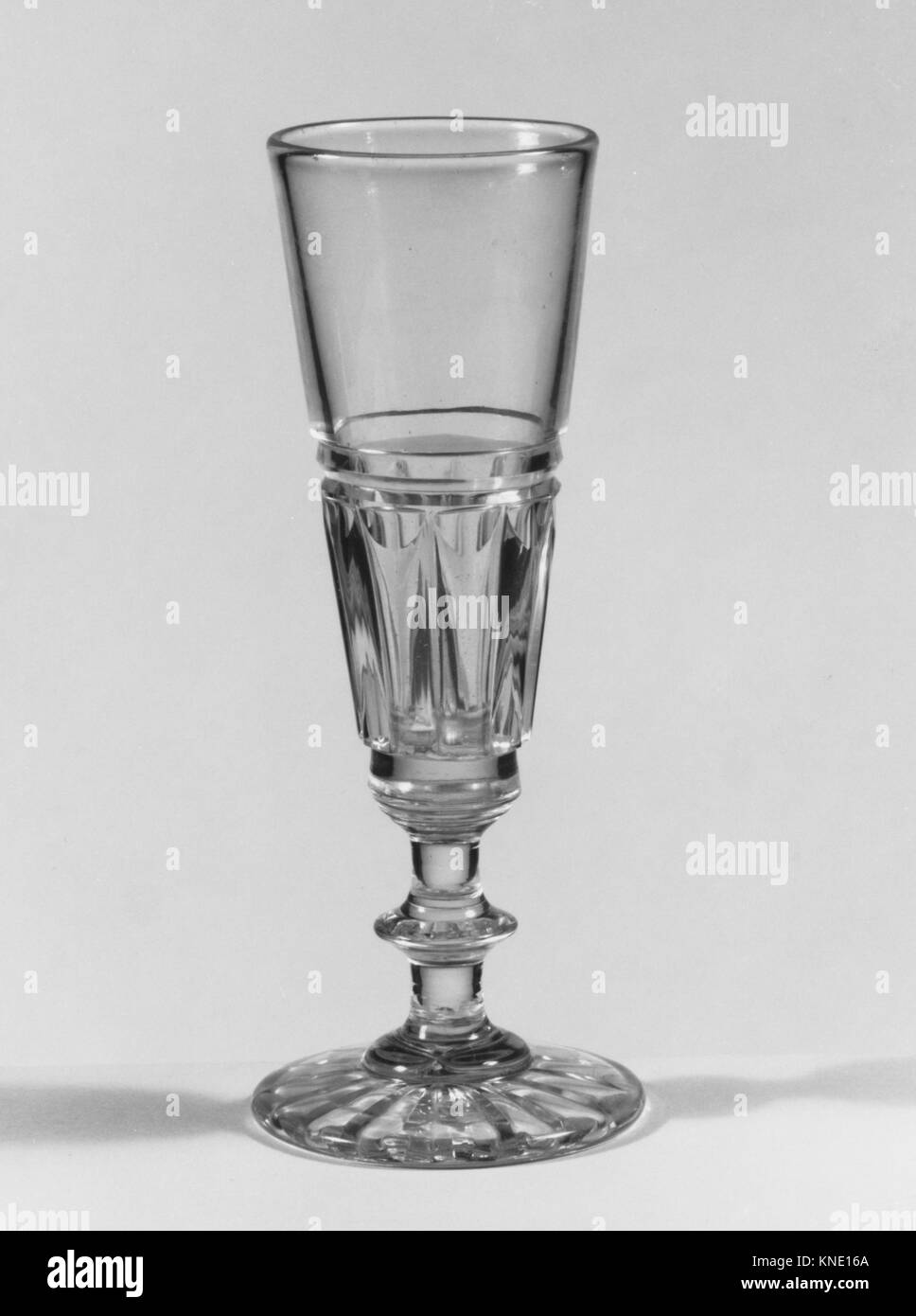 This 19th-century American champagne glass is made of blown lead glass ...