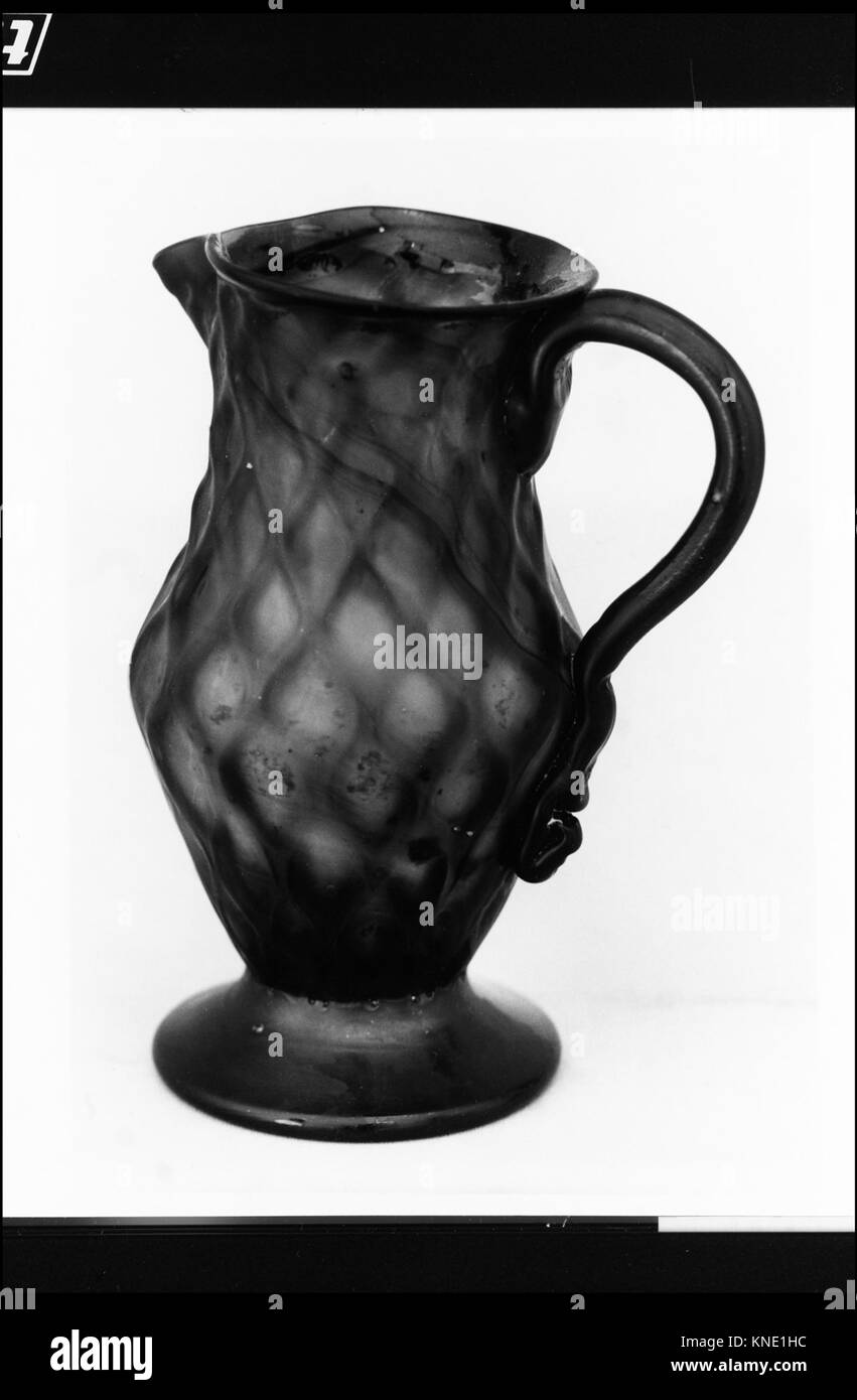 A cream jug, 18th–19th century, made of blown pattern-molded lead blue ...