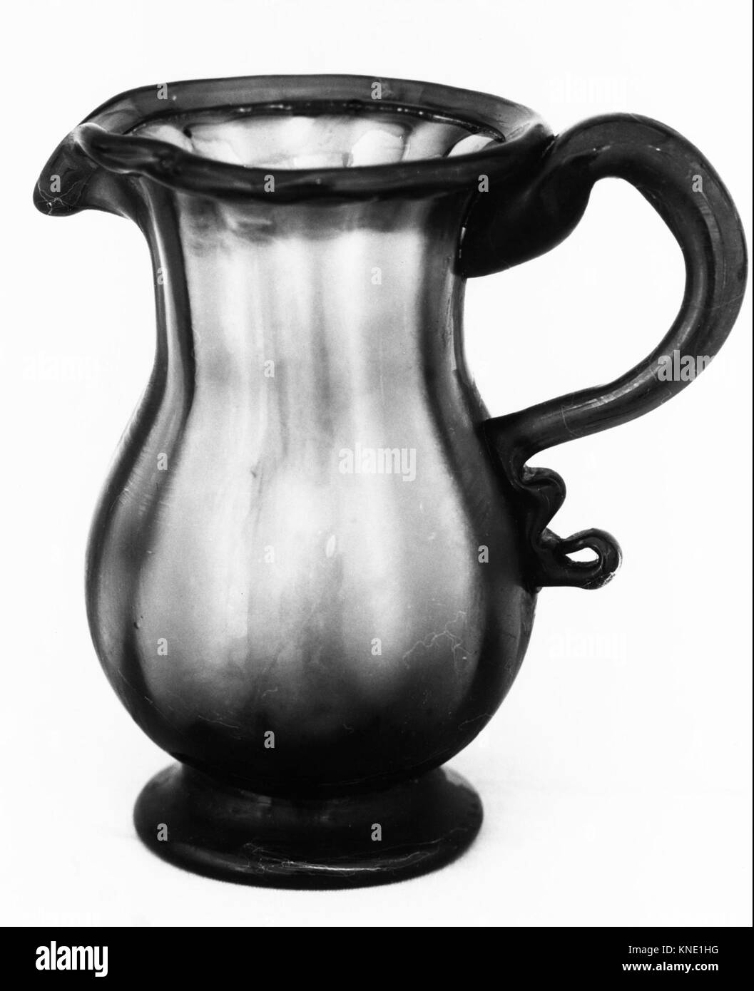A British creamer, 18th century, made of blown pattern-molded lead blue ...